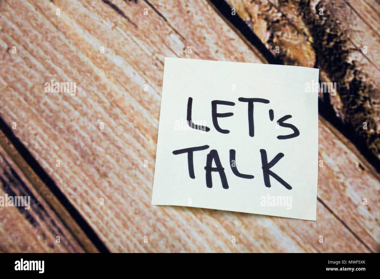 Lets talk concept words on the wooden bark background. Handwritten ...