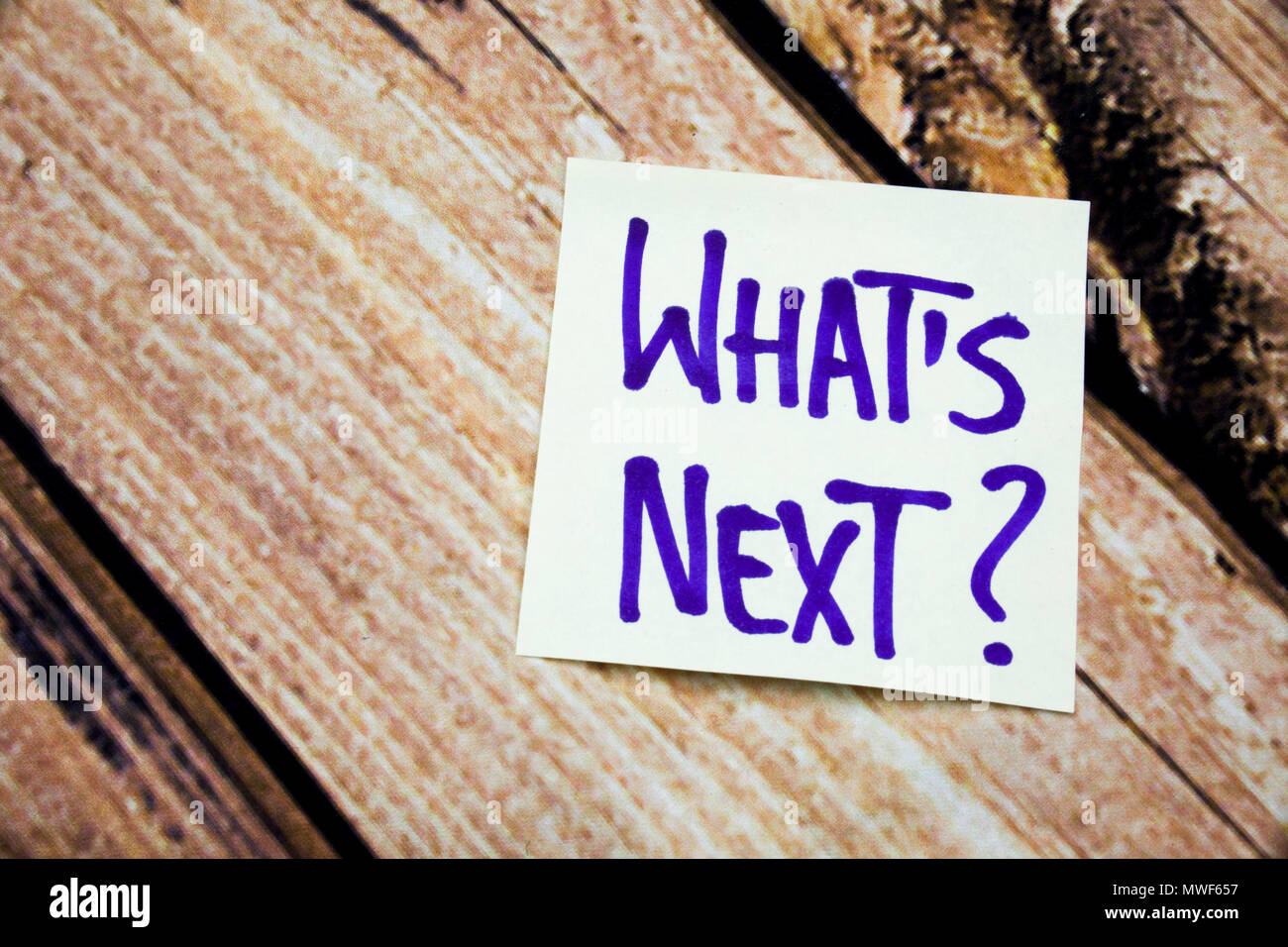 What is next handwritten words on white paper with retro wooden bark ...