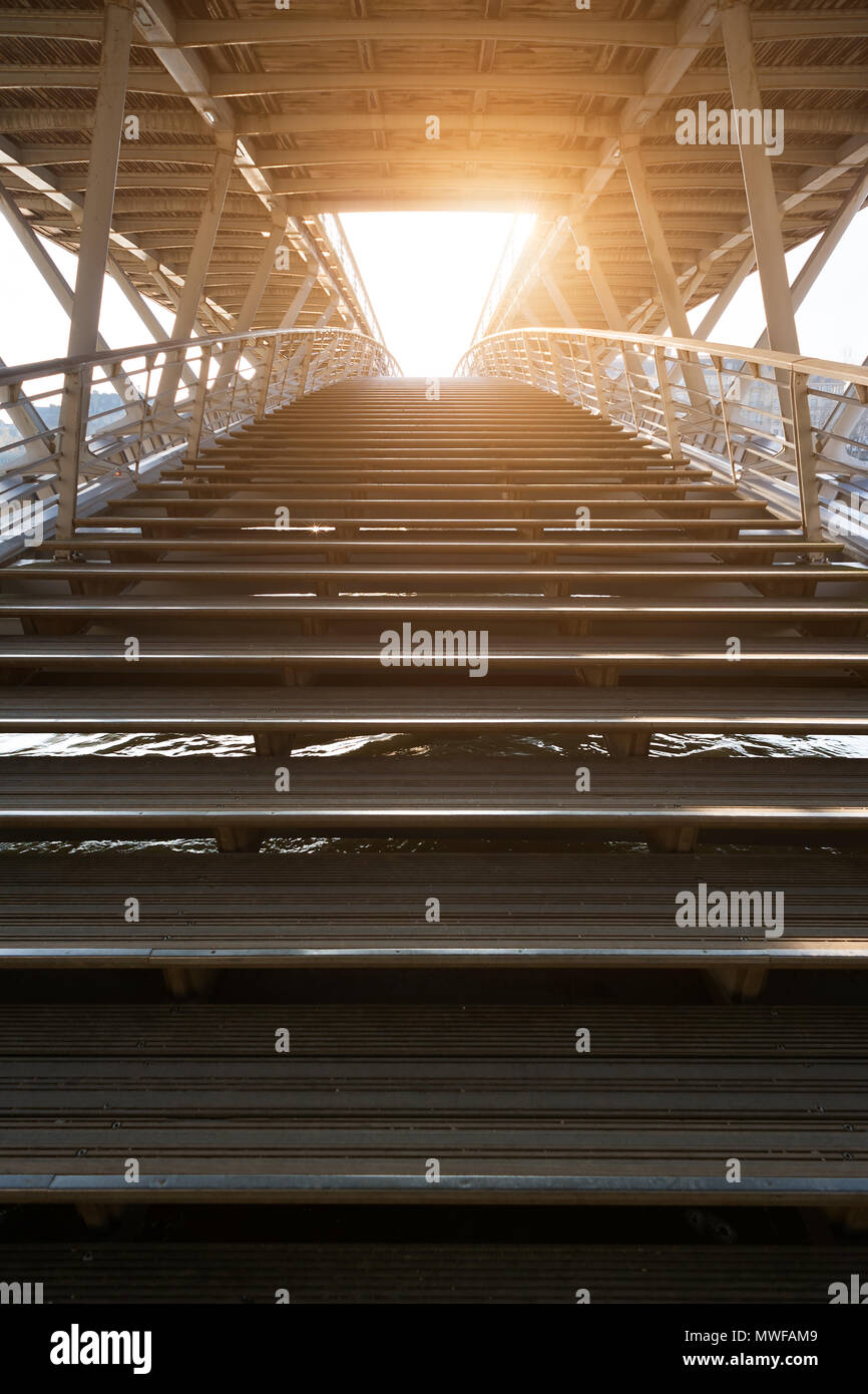 Stairs of solferino pedestrian bridge over river Seine against sun in ...