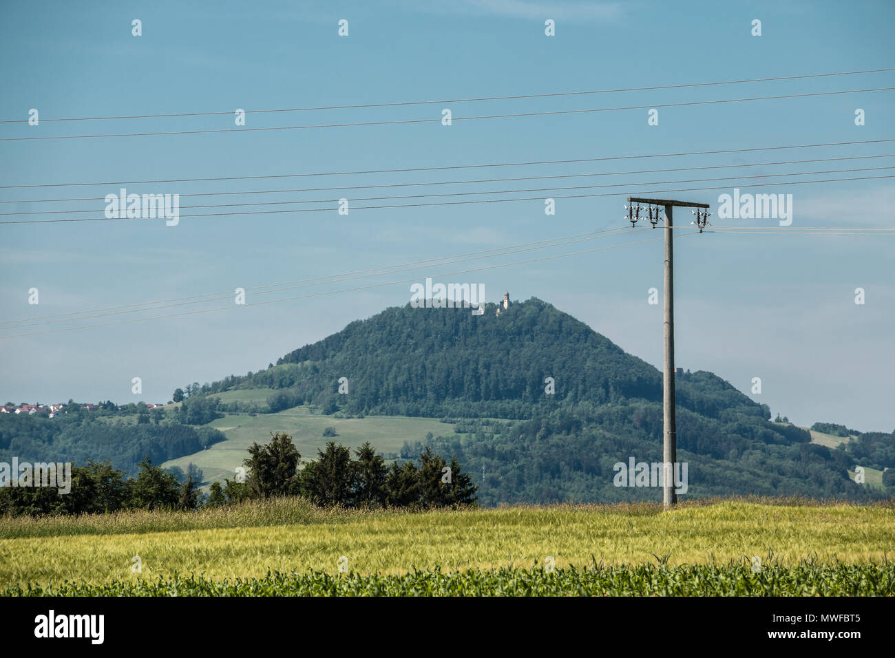 Power pylon in the German countryside with forests, fields and meadows ...