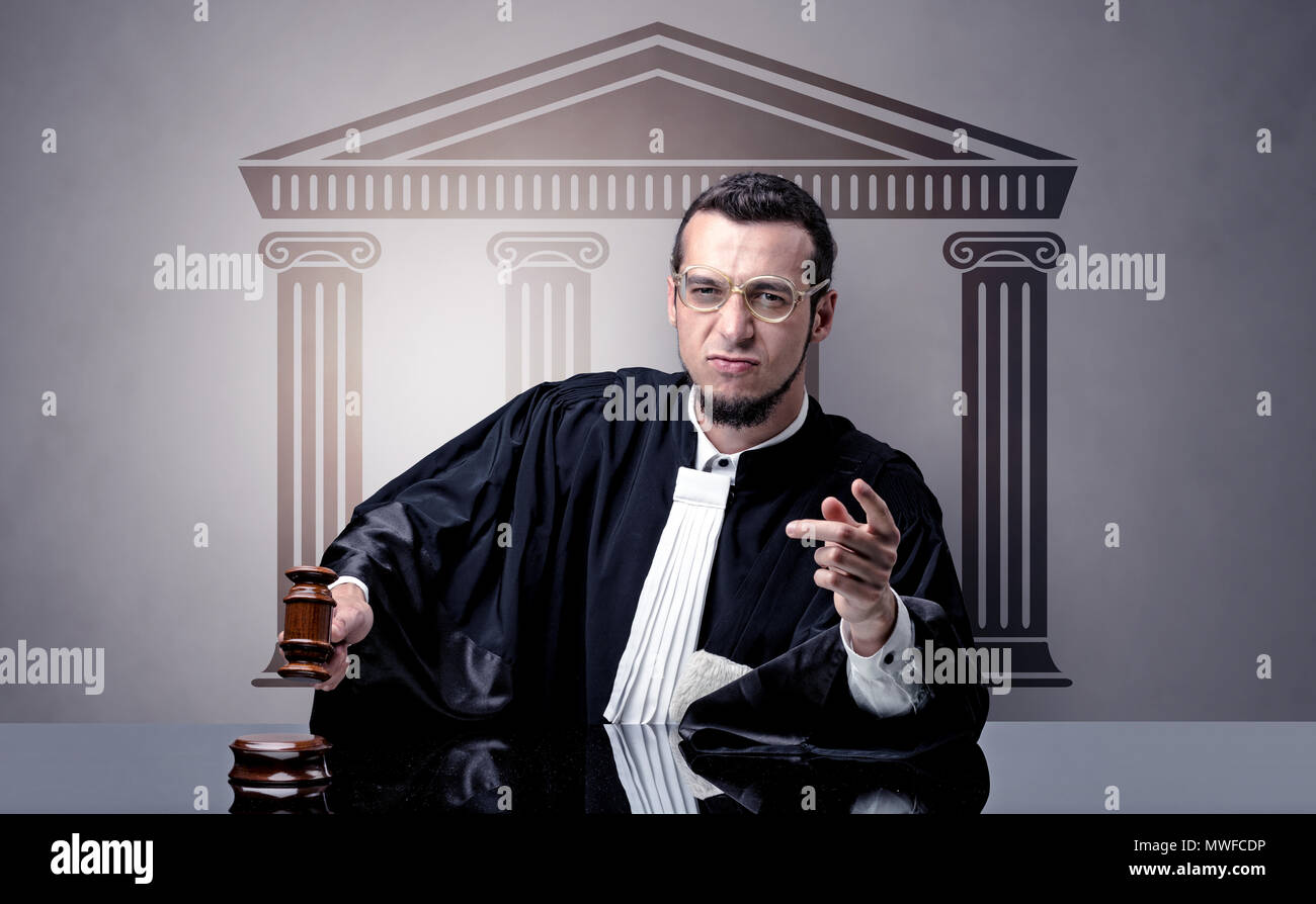 Young judge in front of a courthouse symbol making decision Stock Photo ...