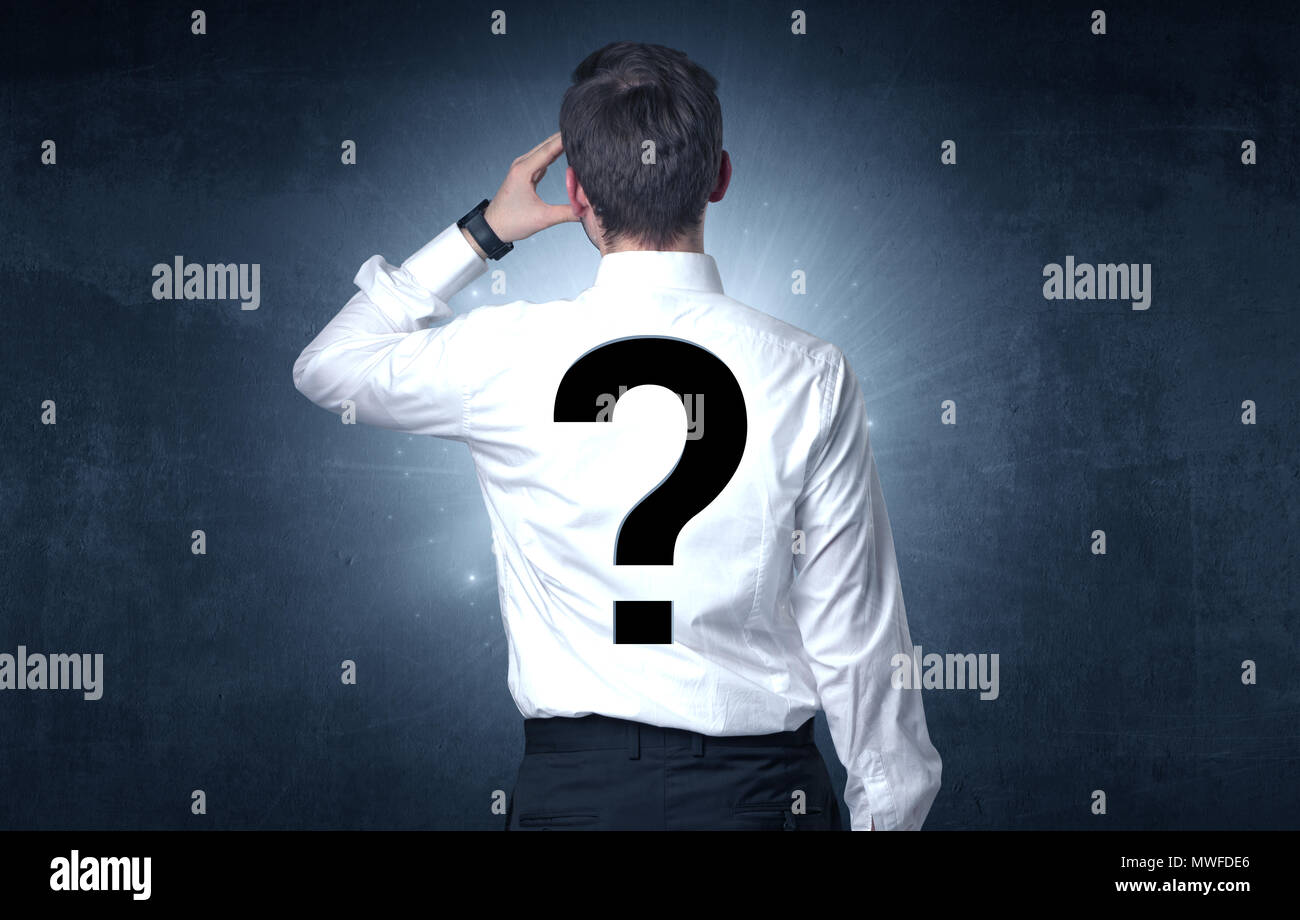 Businessman standing and thinking about questions Stock Photo - Alamy