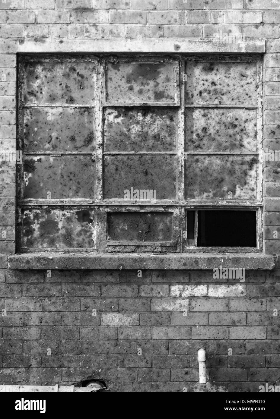 Abandoned building broken window frames and urban decay Stock Photo - Alamy