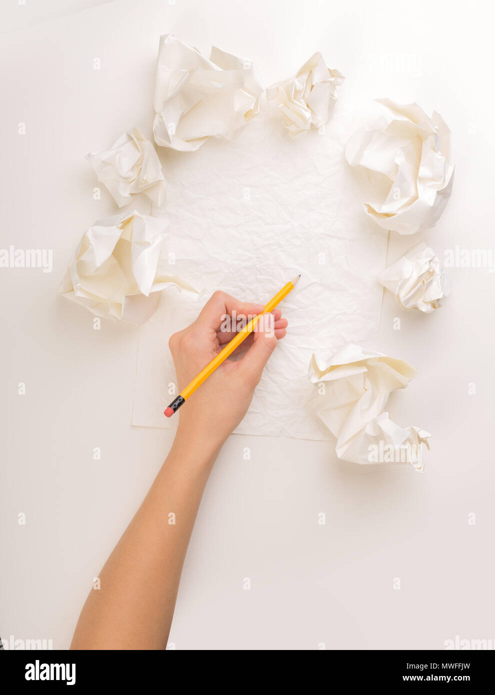 Female hand trying to write next to a few crumpled paper balls Stock ...