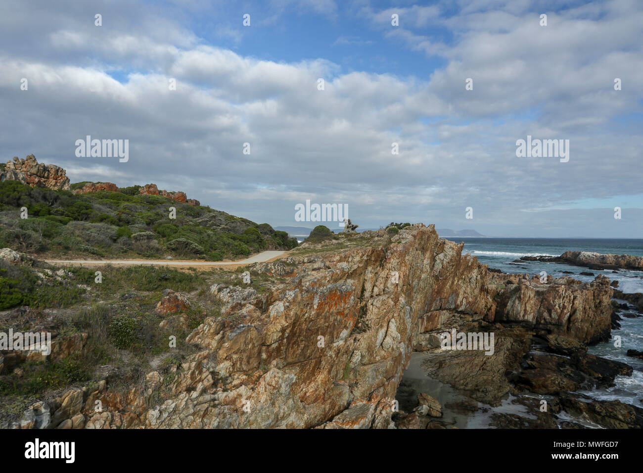 Dramatic rocks sea and blue sky along the hermanus cliff path on the ...