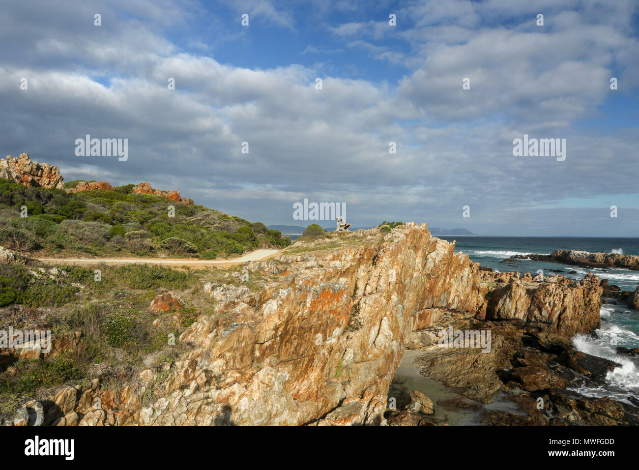 Dramatic rocks sea and blue sky along the hermanus cliff path on the ...