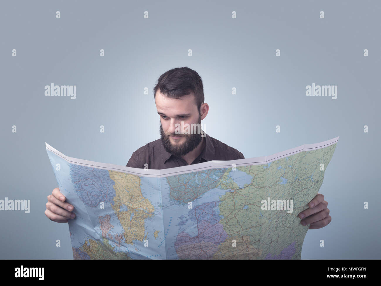 Handsome young man holding map Stock Photo - Alamy