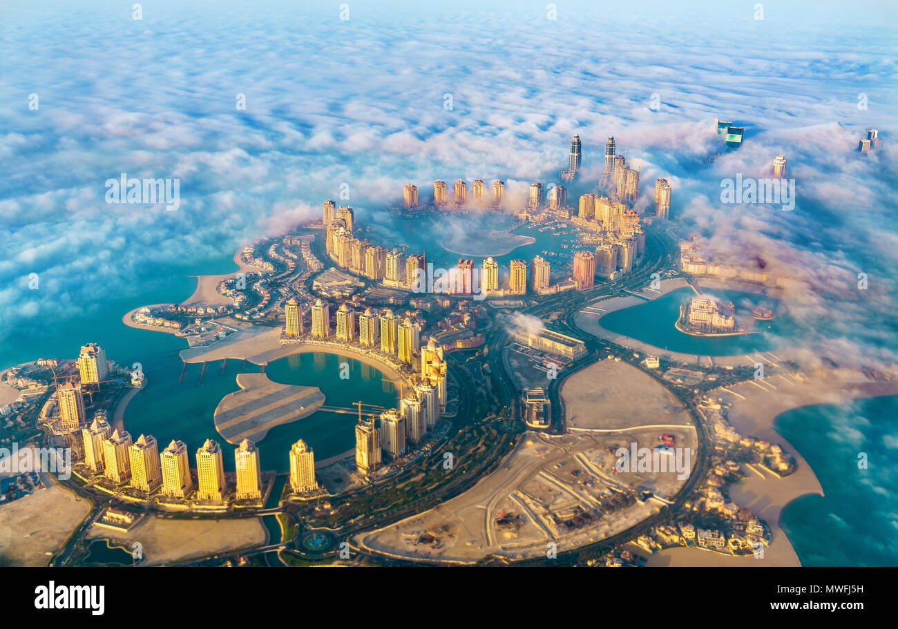 Aerial view of the Pearl-Qatar island in Doha through the morning fog ...