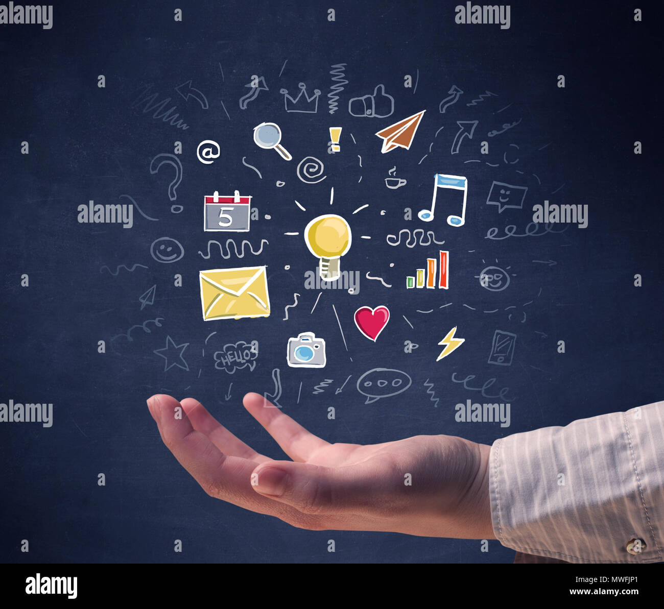 Colorful mixed media icons hovering over young hand Stock Photo - Alamy