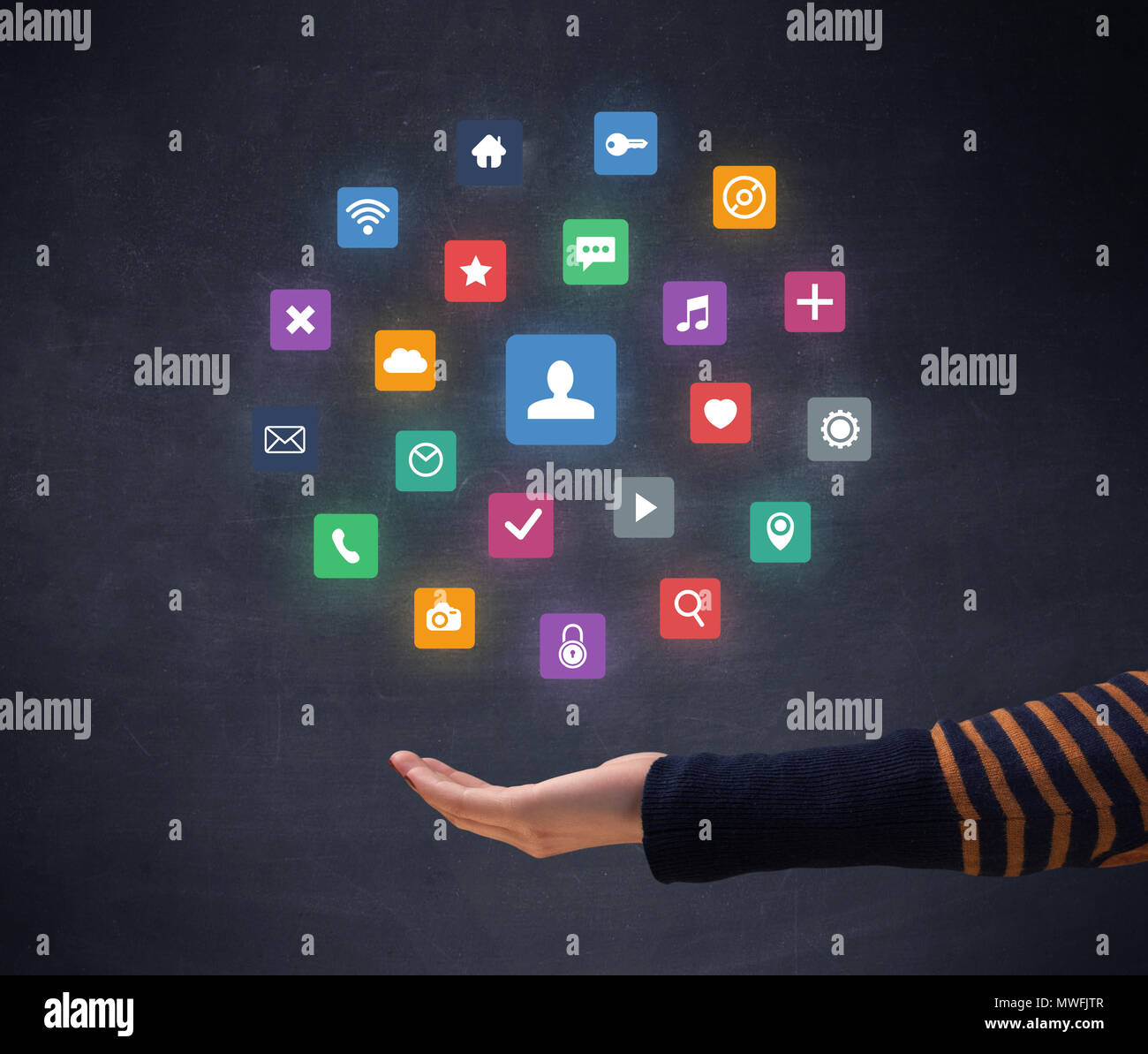 Colorful applications hovering over young hand Stock Photo - Alamy
