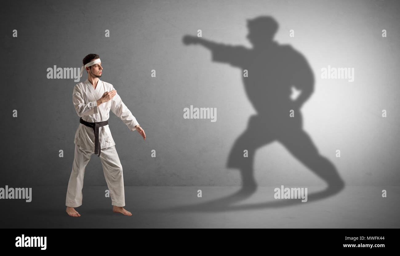Young karate man confronting with his own shadow Stock Photo - Alamy