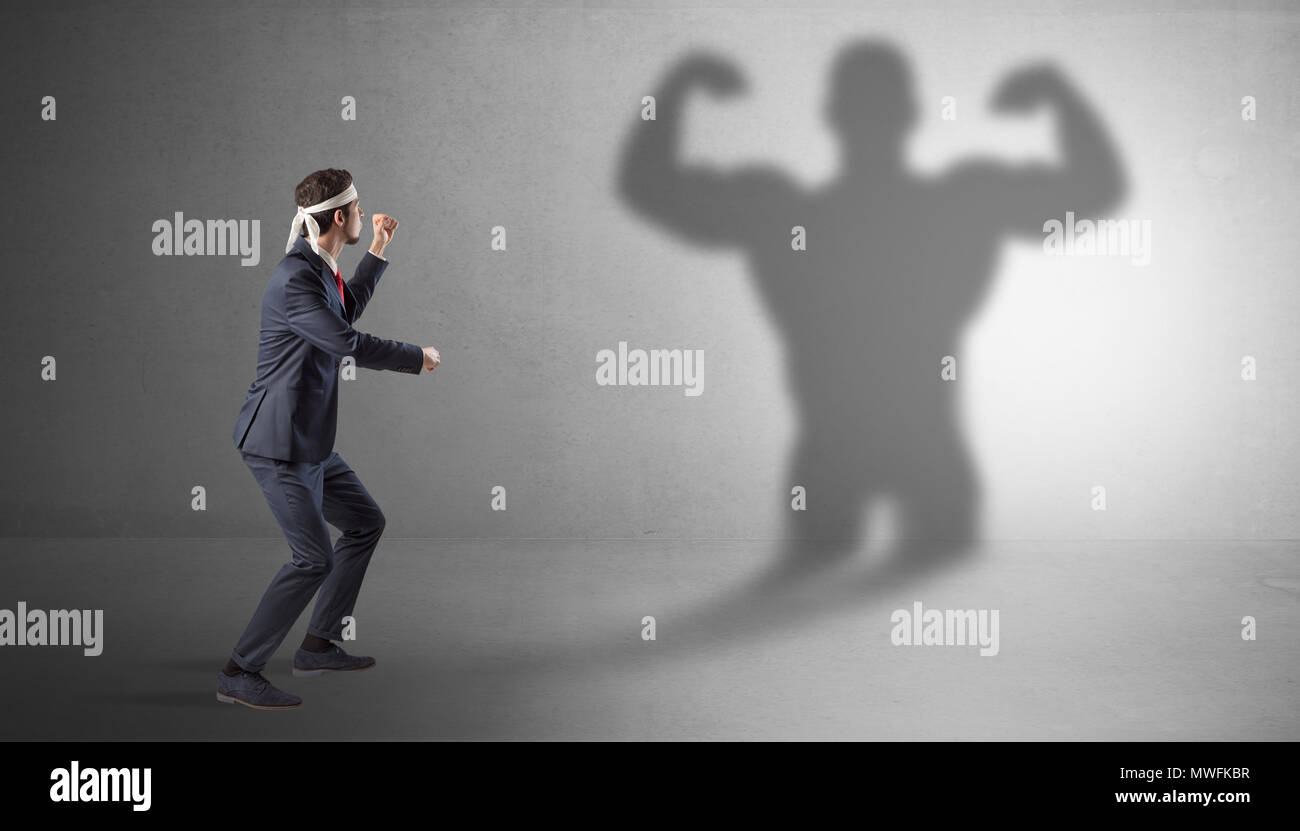 Businessman fighting with his bossy yelling shadow Stock Photo - Alamy