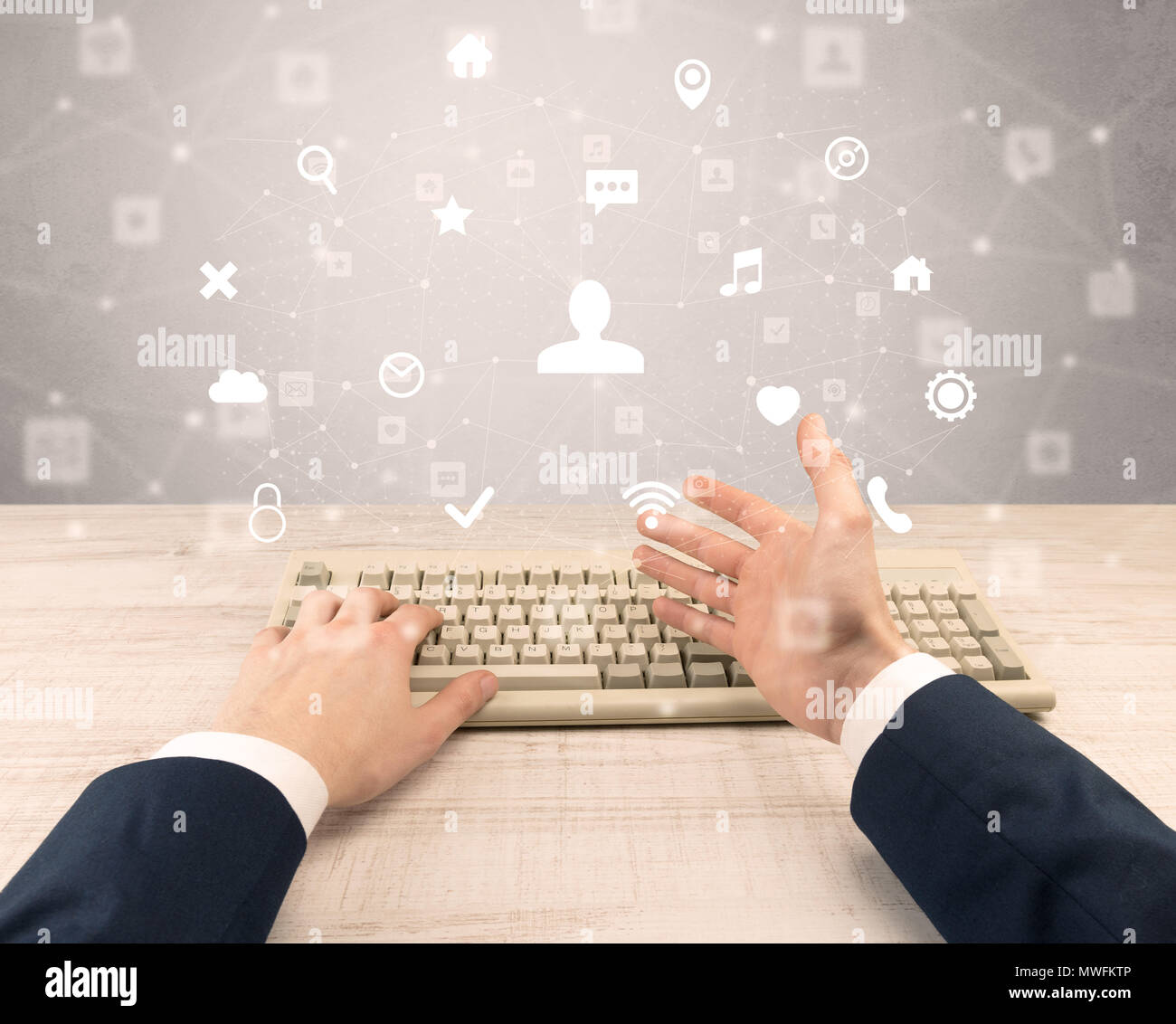 First person view of hand typing with social media concept icons around ...