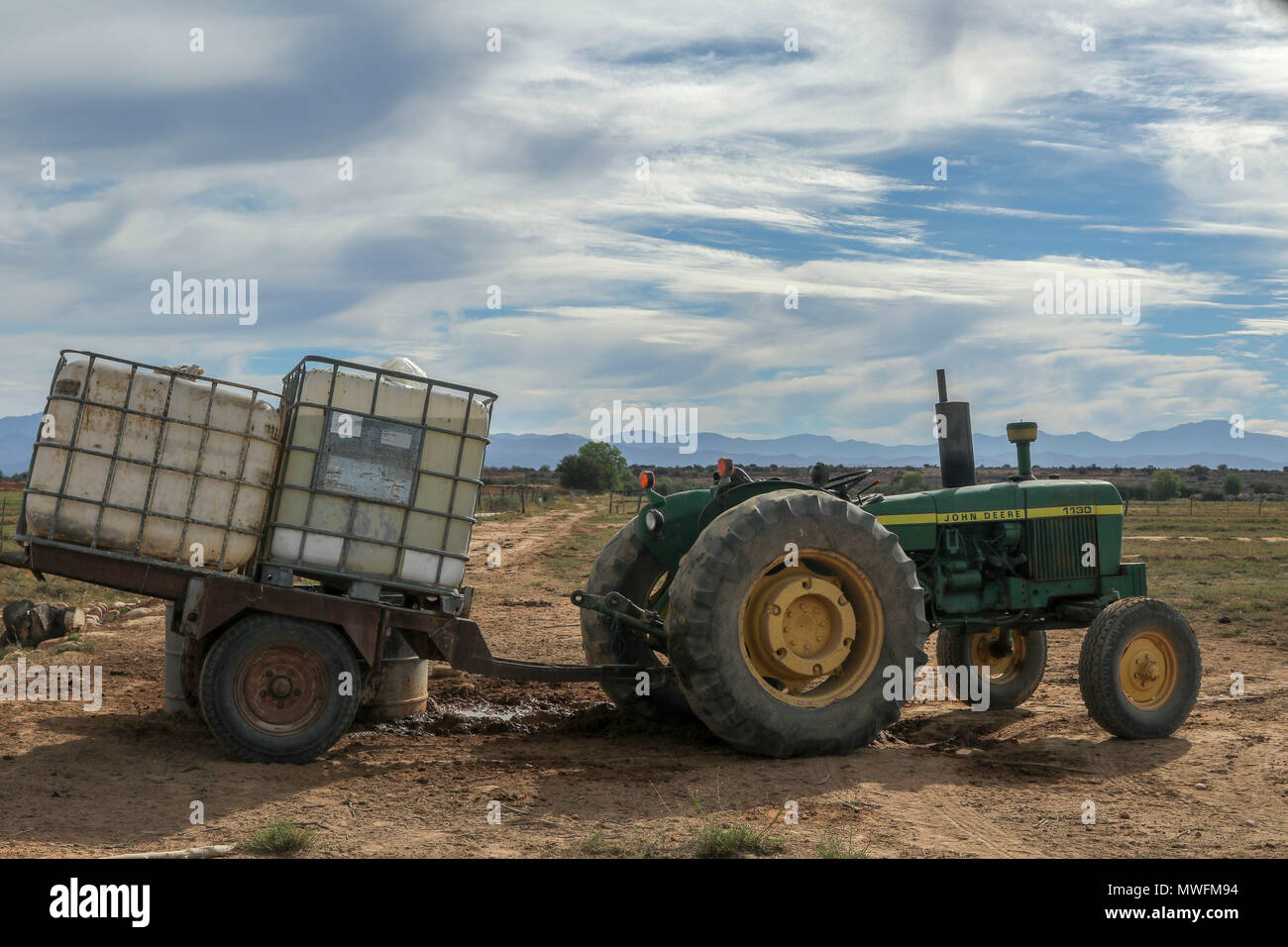 Green tractor and load on farmland on the garden route south africa ...