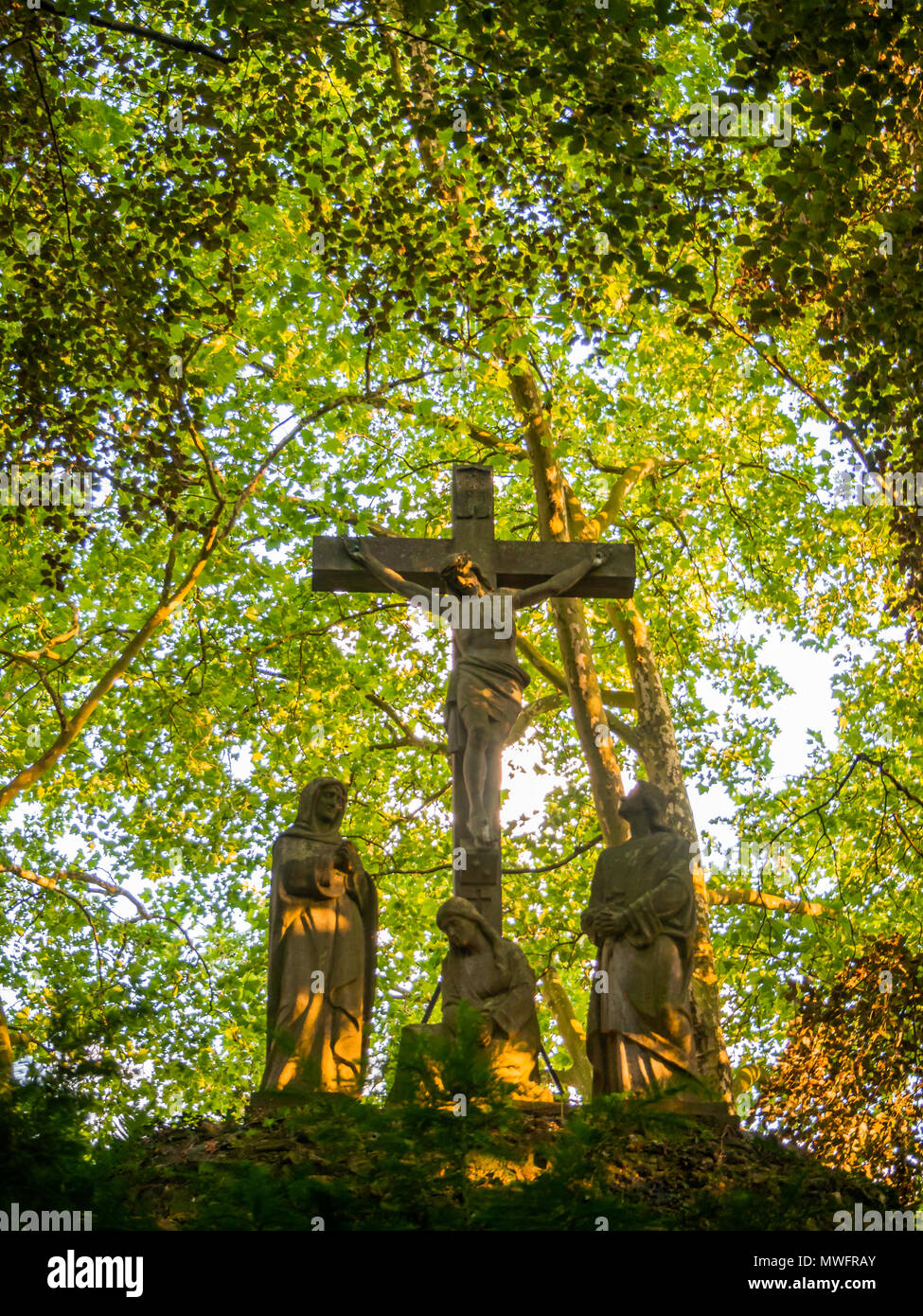 Statue of the crucifixion of Jesus in a forest Stock Photo - Alamy