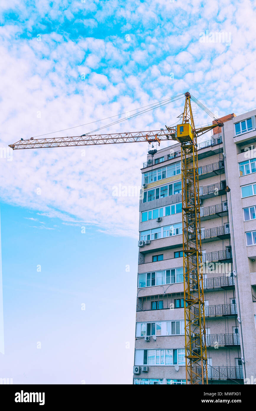 Construction crane against the building Stock Photo - Alamy