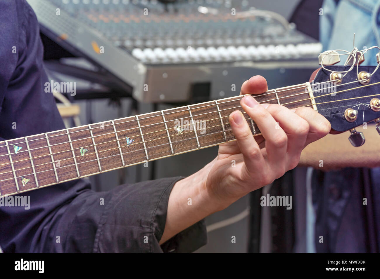 The hand of the guitarist on fingerboard Stock Photo - Alamy