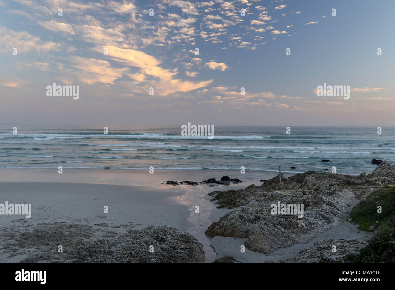 wood structure and mottled sky at twilight at Voelklip Beach on the ...