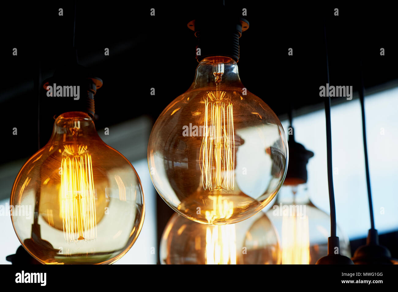 Edison light bulb hanging on a long wire. Cozy warm yellow light.Retro ...