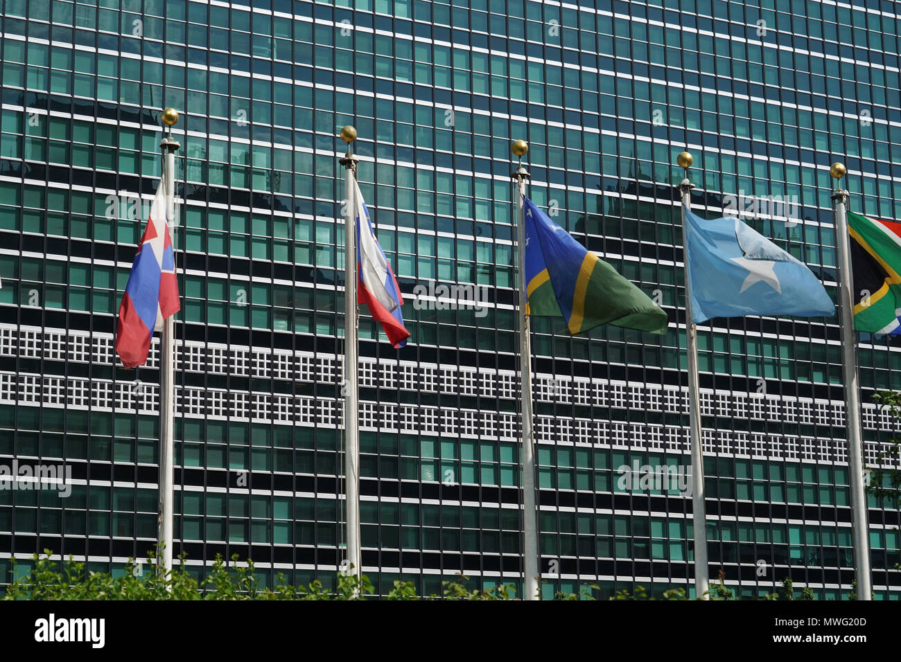 flags waving outside united nations building in manhattan new york Stock Photo - Alamy