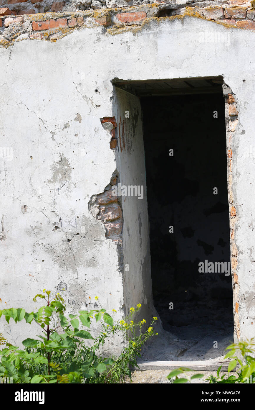 Entrance to the old destroyed building. Hole from a bullet in the wall ...
