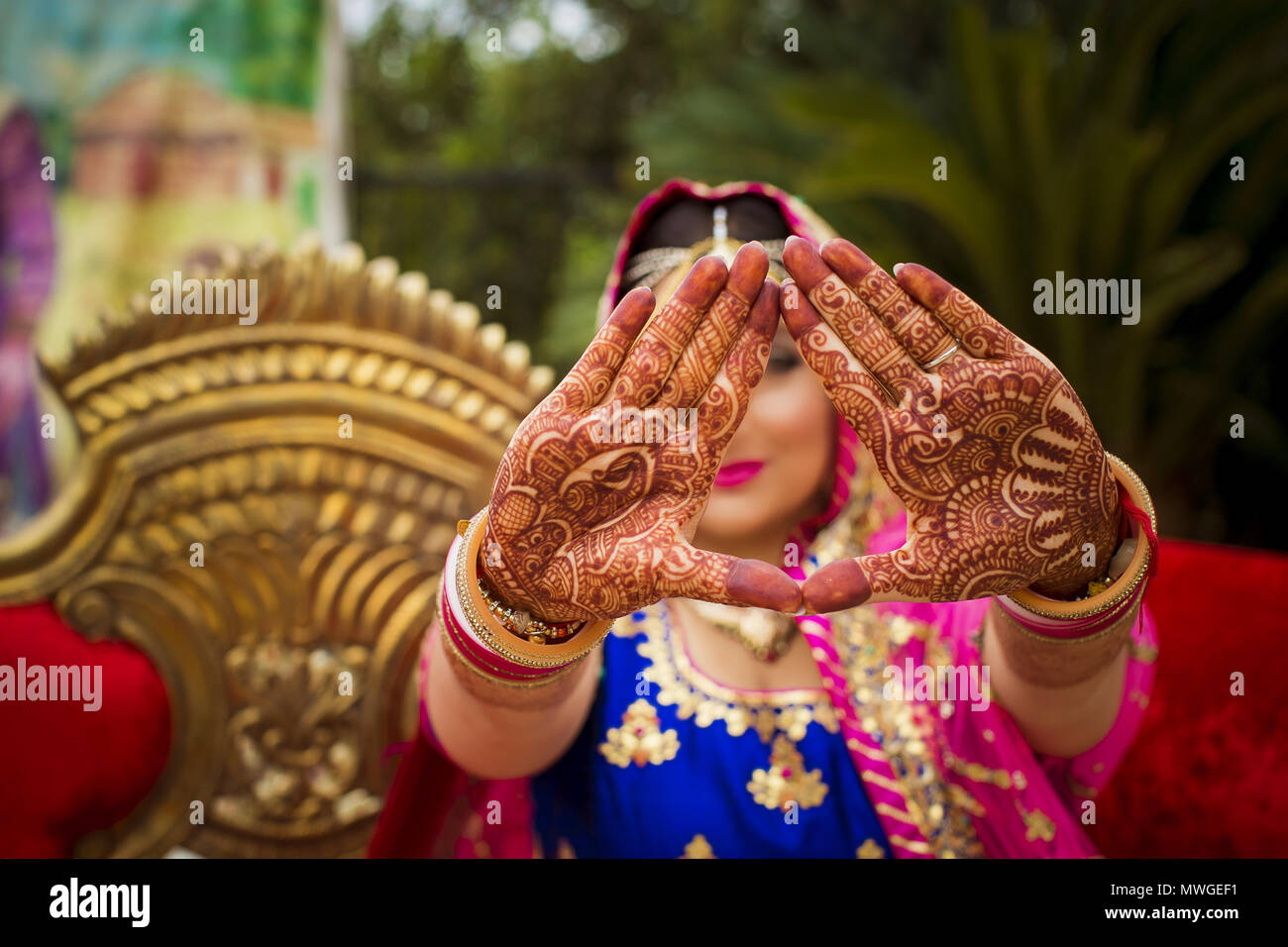 Pakistani & Indian bride wedding making a heart shape her hand style ...