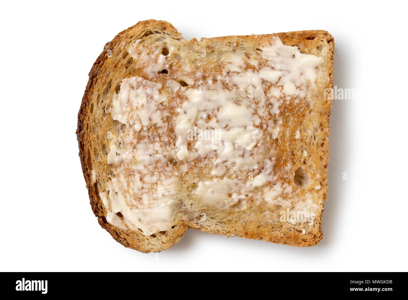 Butter spread on a single slice of whole wheat toast isolated on white ...