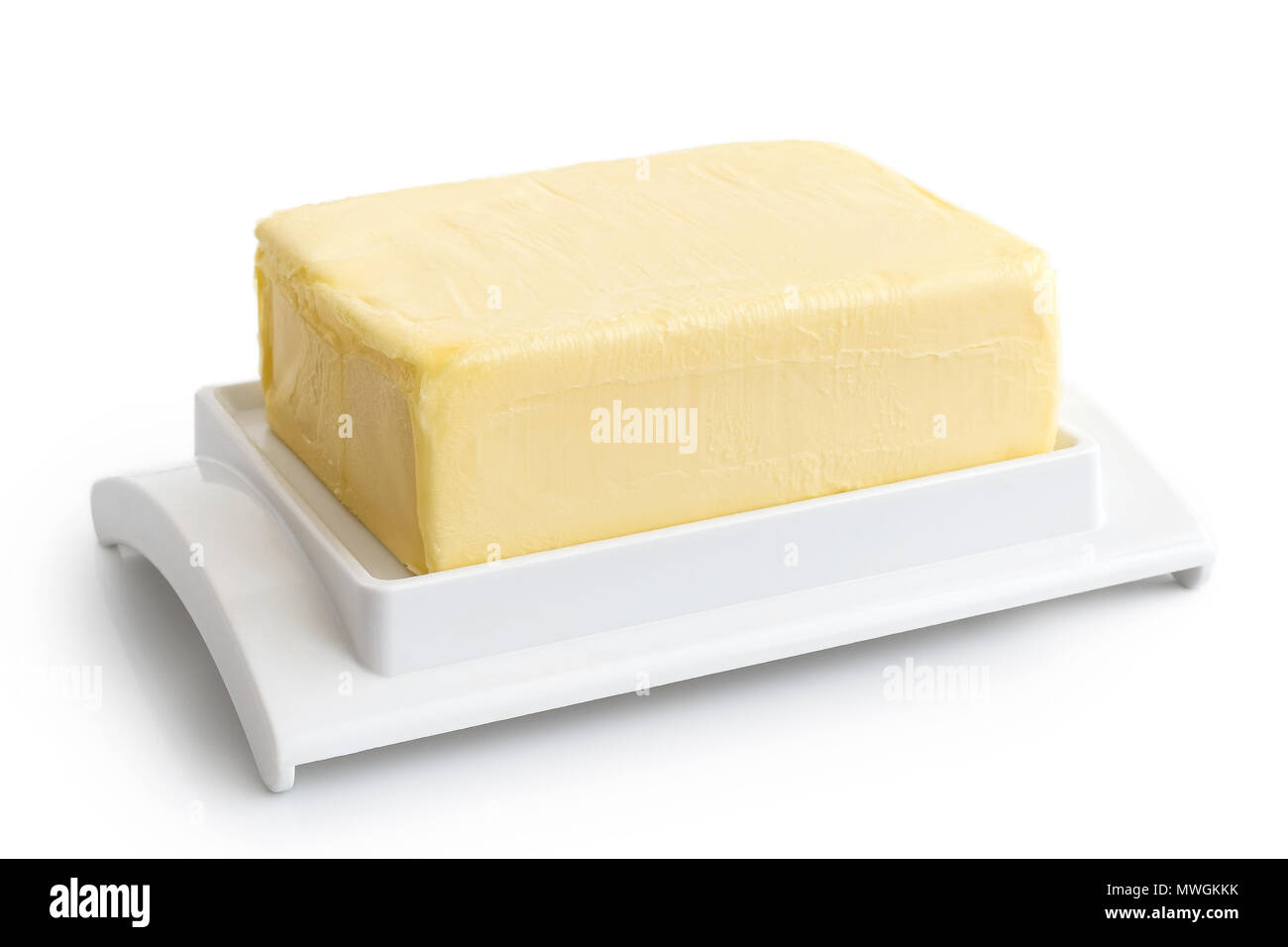 A whole block of butter on white plastic butter dish isolated on white ...