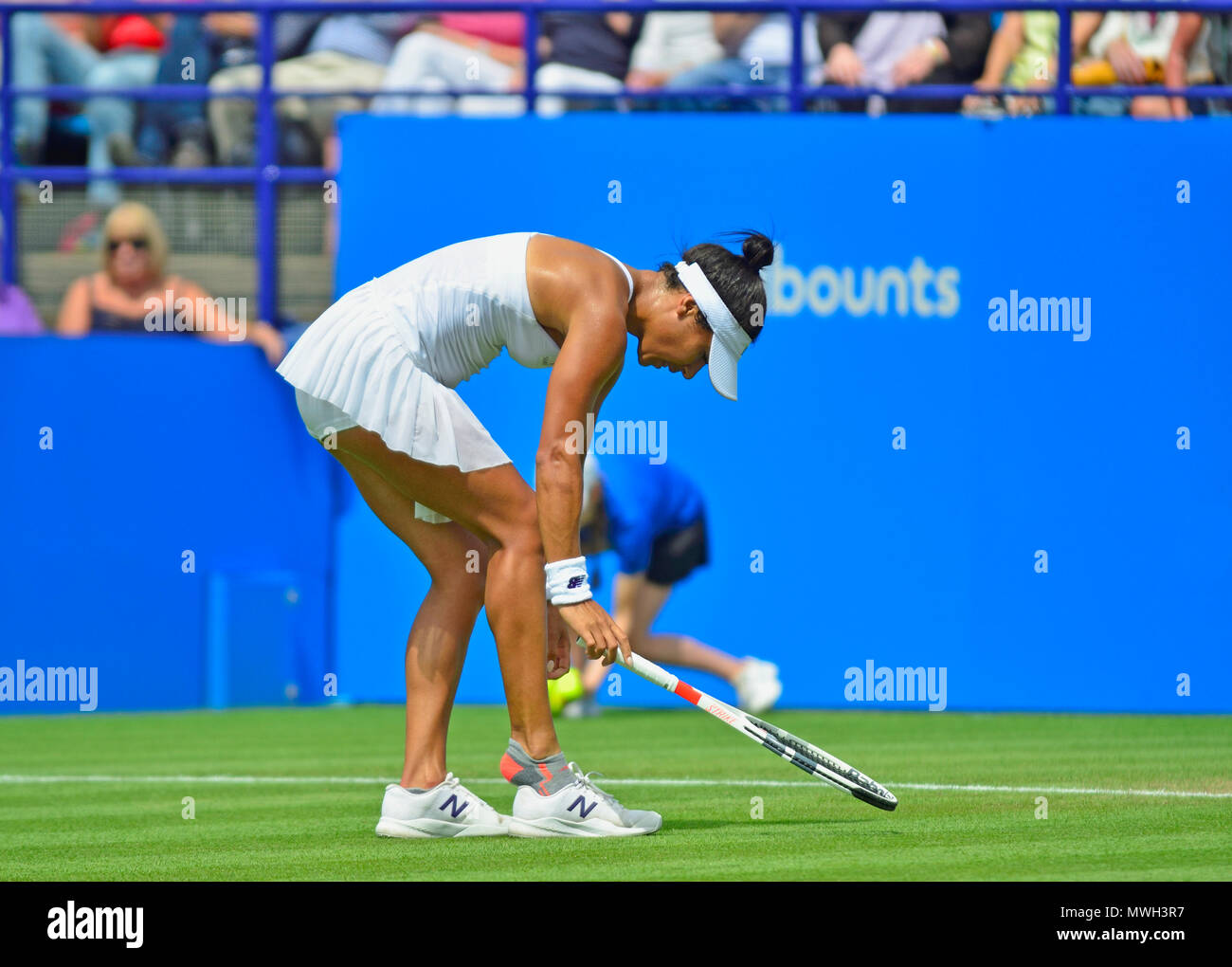 Heather Watson (GB) fixing her footwear on centre court at the Aegon ...