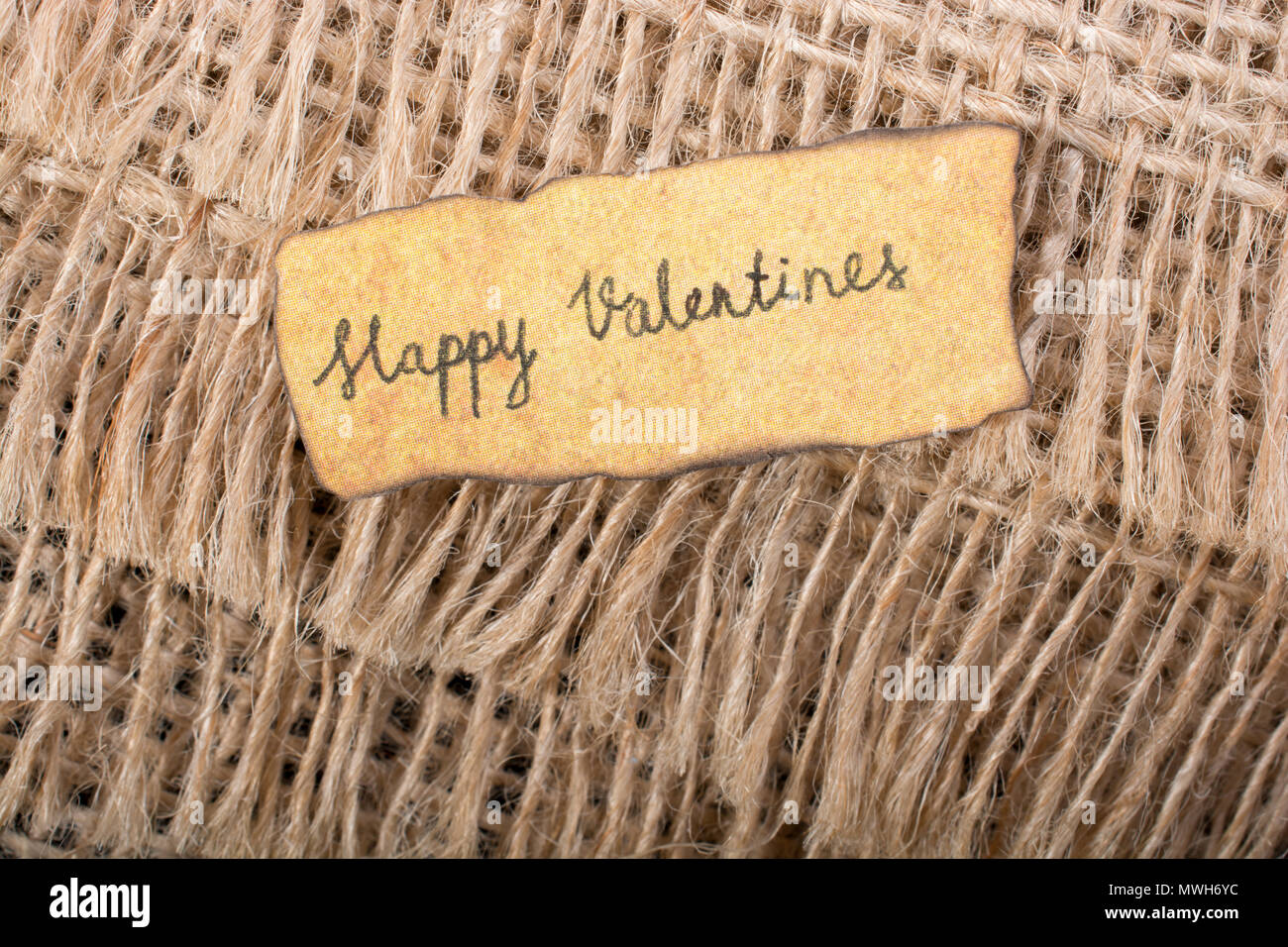 Valentine's day wording on torn paper as Love concept Stock Photo - Alamy