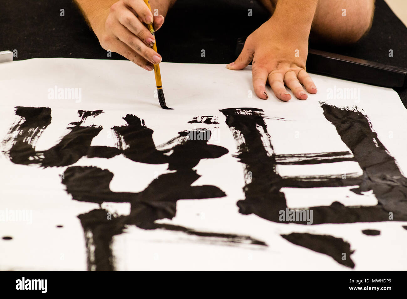 A man practicing Japanese calligraphy Stock Photo - Alamy