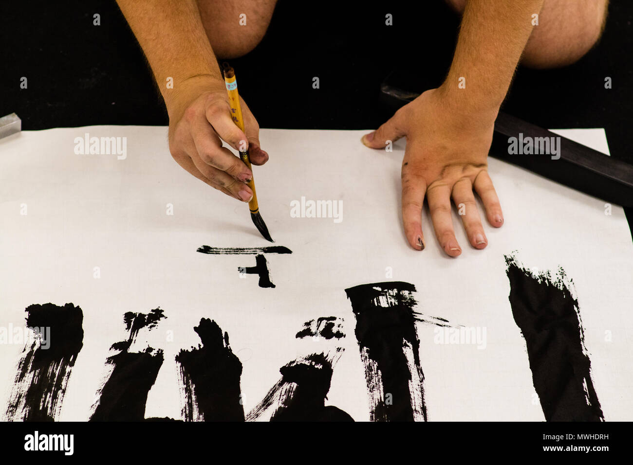 A man practicing Japanese calligraphy Stock Photo - Alamy
