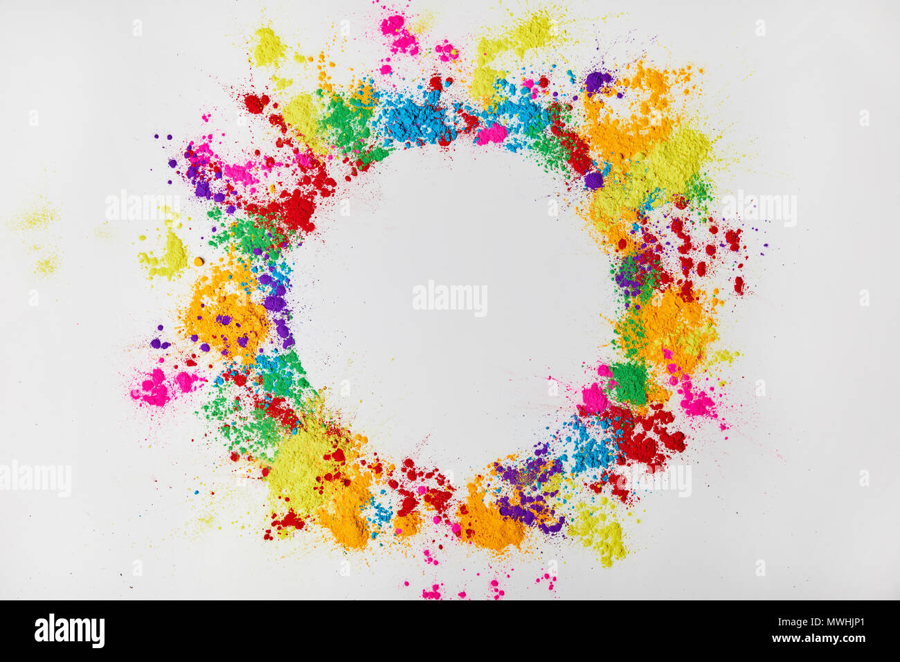 circle frame of multicolored traditional powder, isolated on white ...