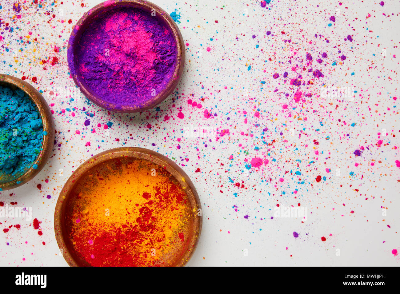 top view of colorful holi powder in bowls isolated on white ...