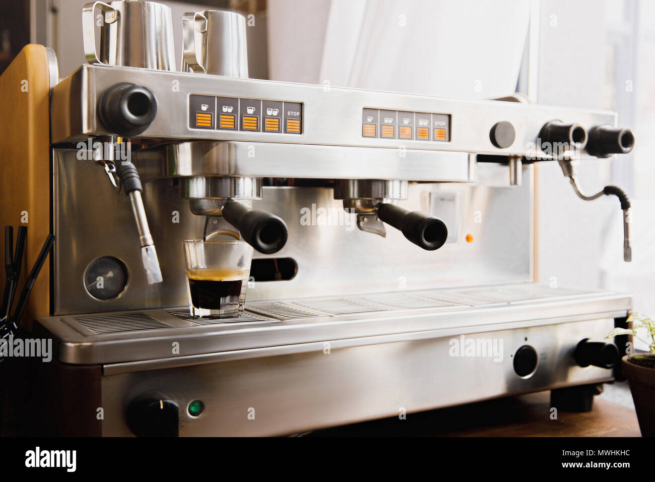 Cooking coffee on modern espresso machine Stock Photo - Alamy