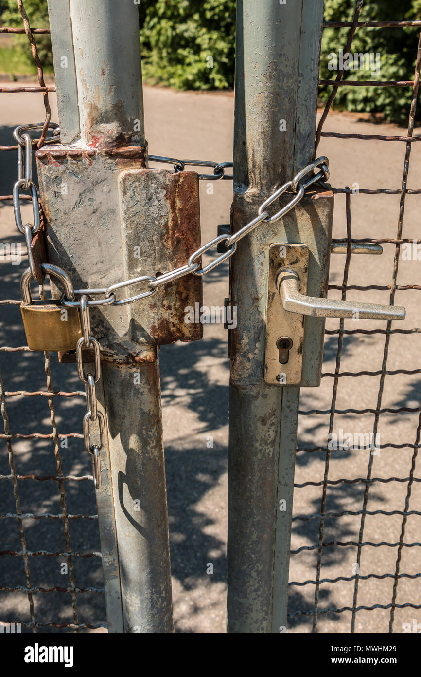 Closed gate with big steel chain and padlock Stock Photo - Alamy