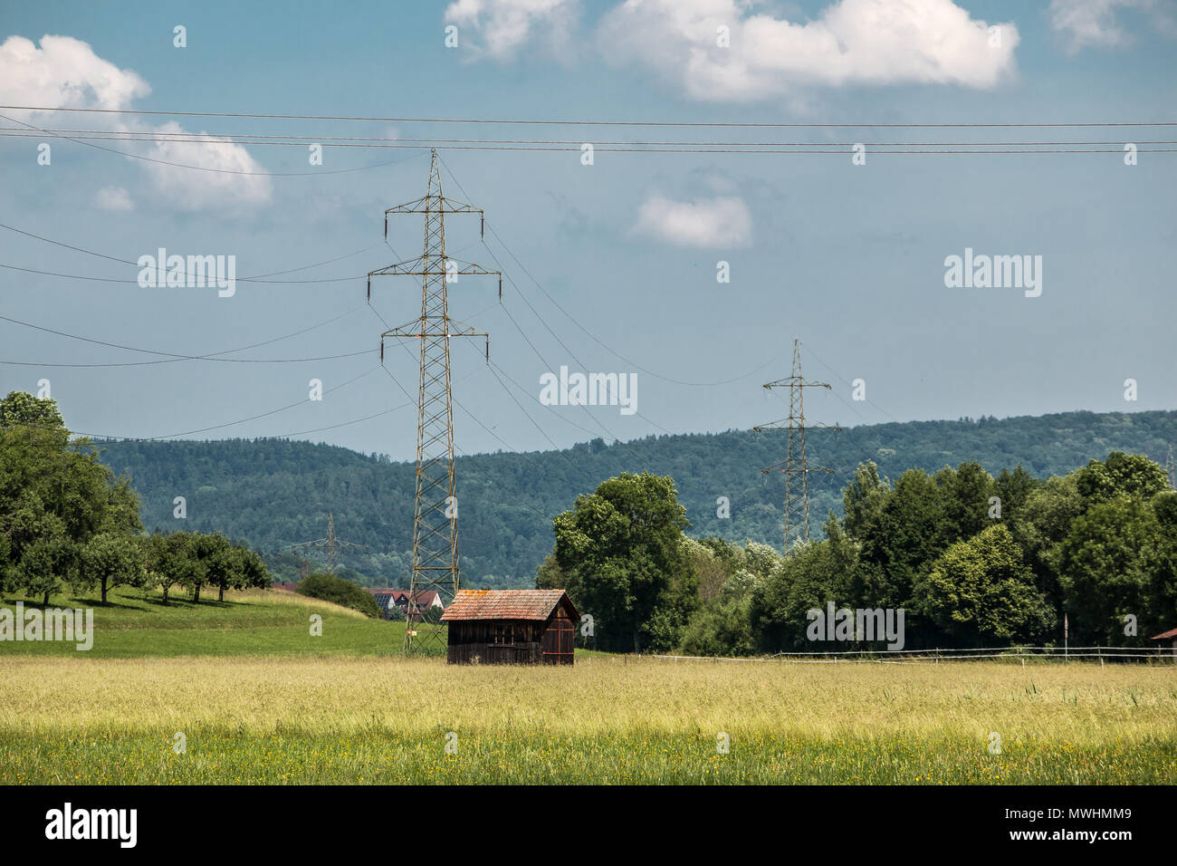 Power pylon in the German countryside with forests, fields and meadows ...