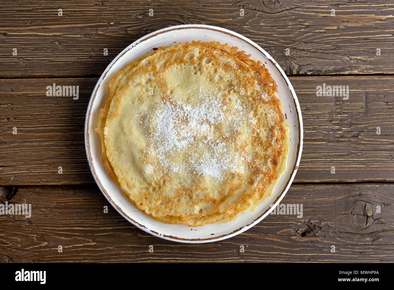 Thin pancakes, sweet crepes on wooden background. Top view, flat lay ...