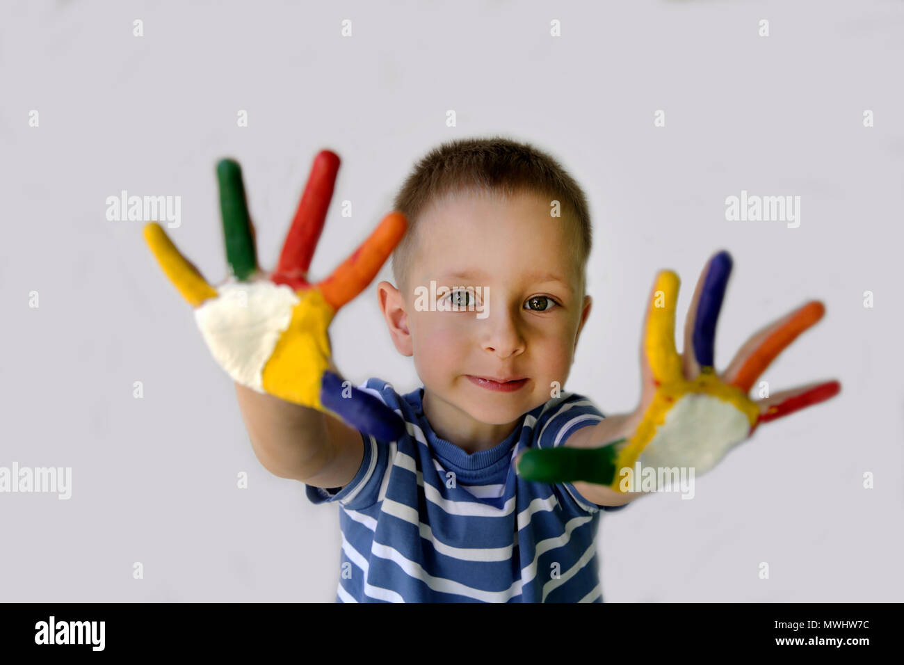 Cute little boy with painted hands Stock Photo - Alamy