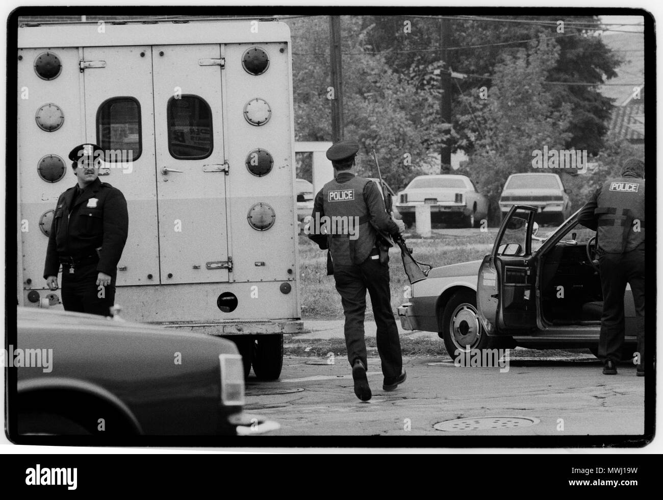 Detroit Michigan USA. 1988 Armed Policemen react to a shooting incident ...