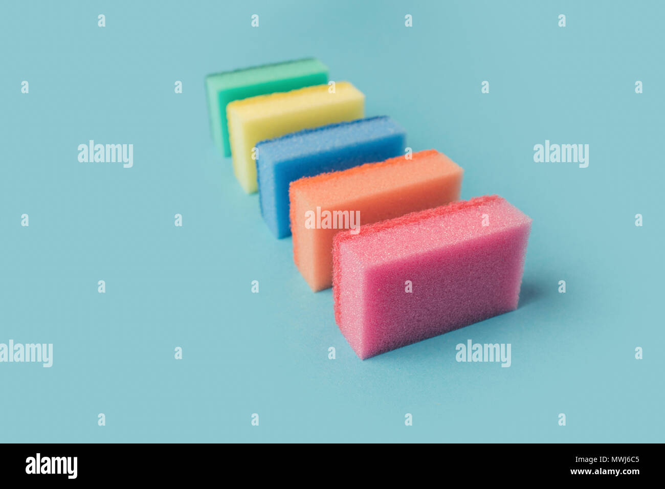 row of colorful washing kitchen sponges, on blue Stock Photo - Alamy