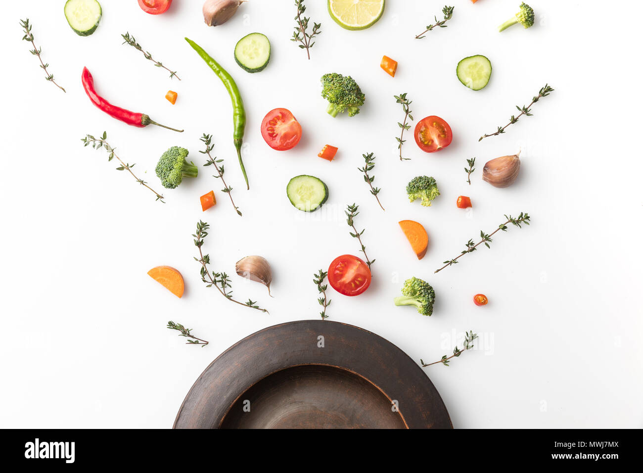 Top view of black plate and cut vegetables isolated on white Stock ...