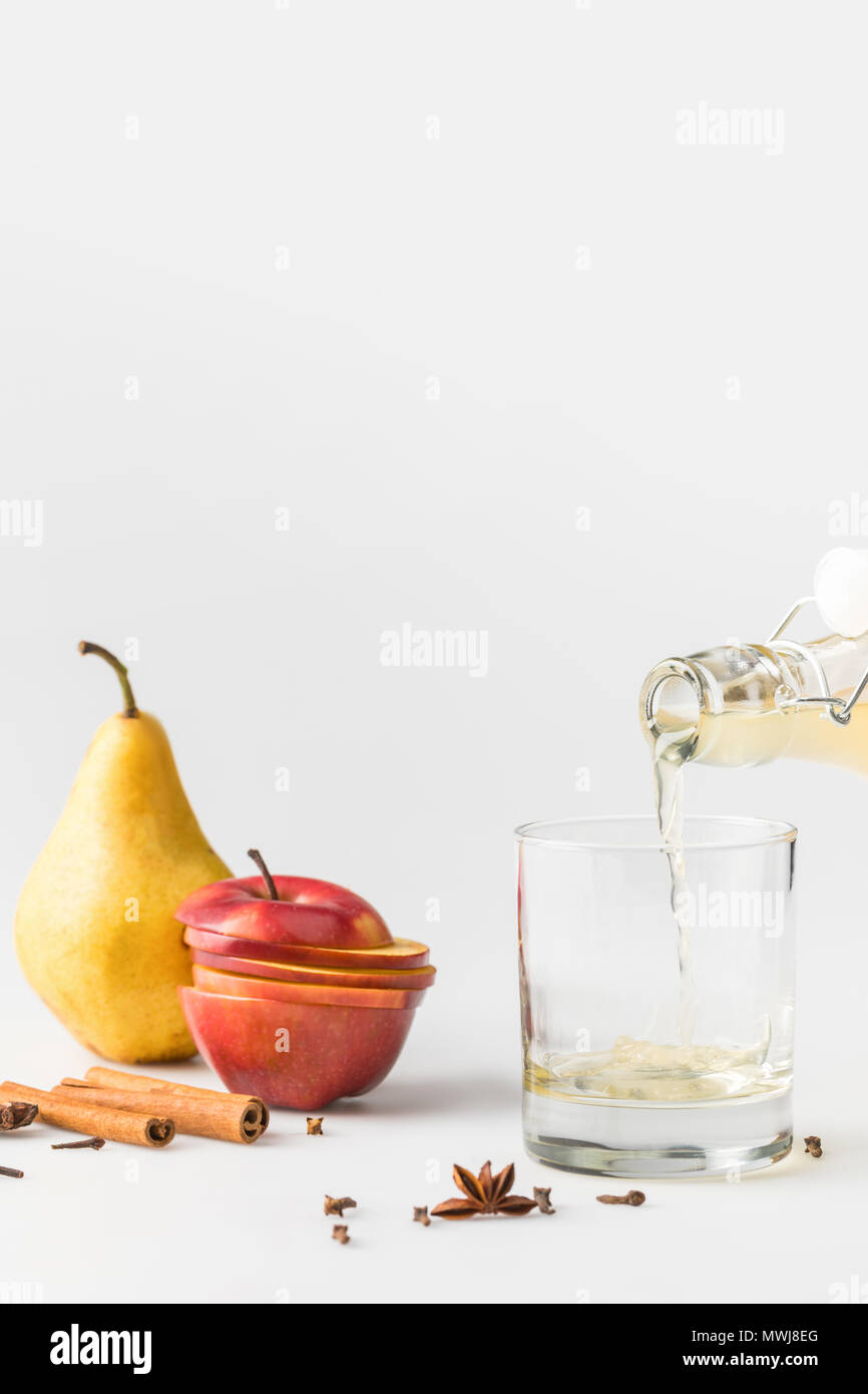 close-up shot of cider pouring in glass on white table Stock Photo - Alamy