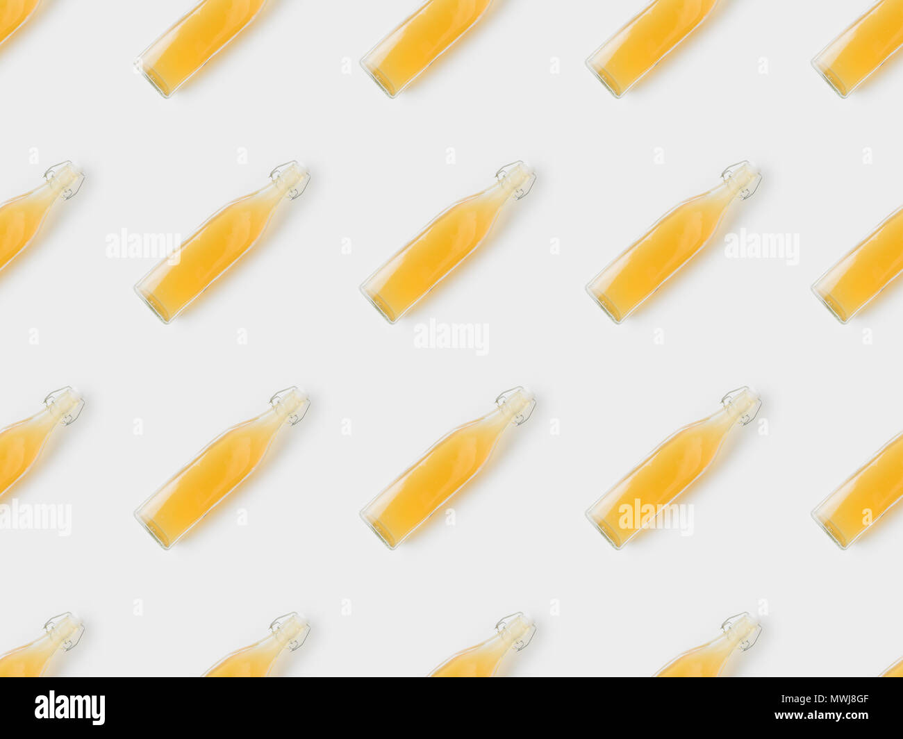 pattern of apple cider bottles on white surface Stock Photo - Alamy