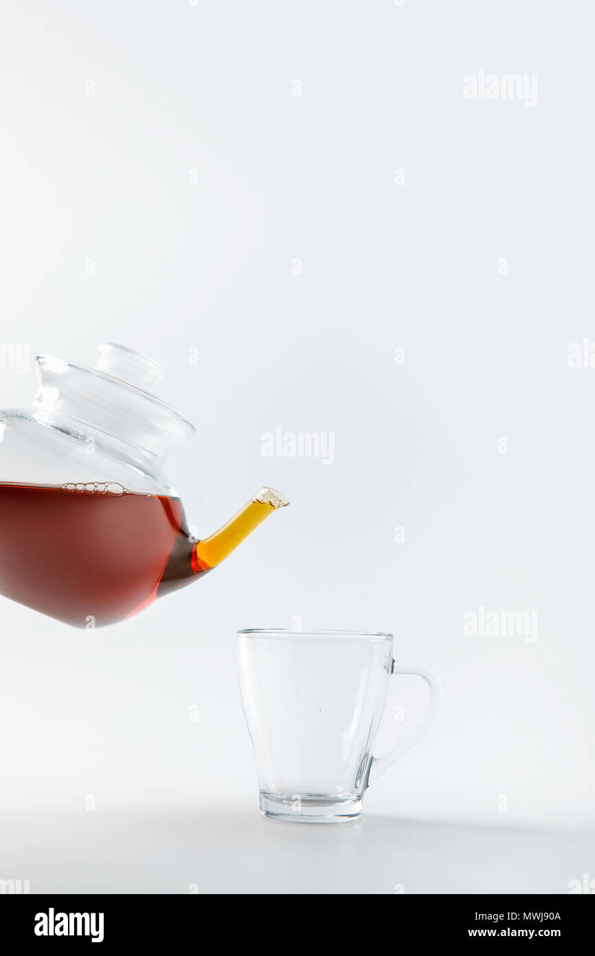 full teapot with cup isolated on white Stock Photo - Alamy