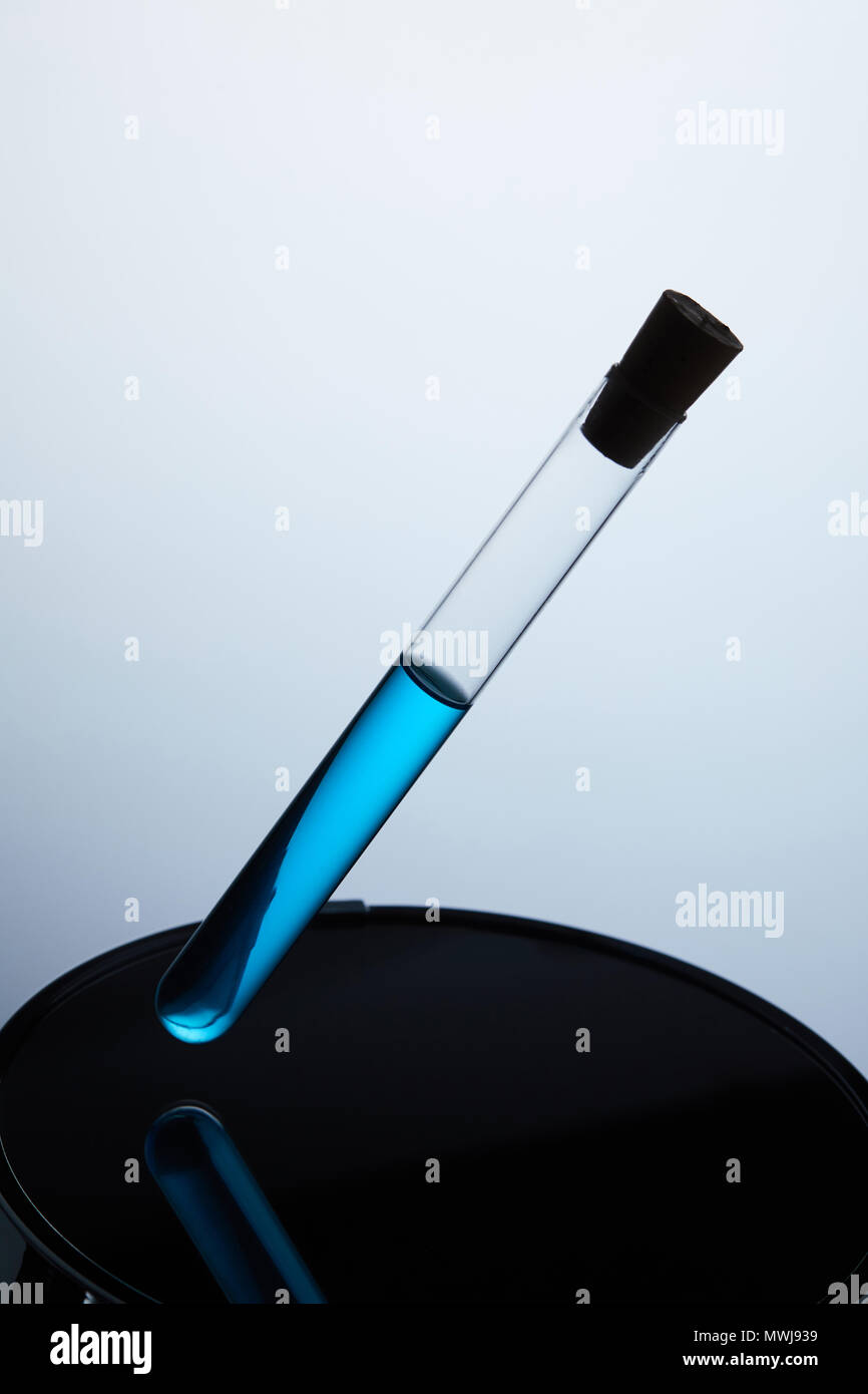 test tube filled with blue liquid on back stand Stock Photo - Alamy