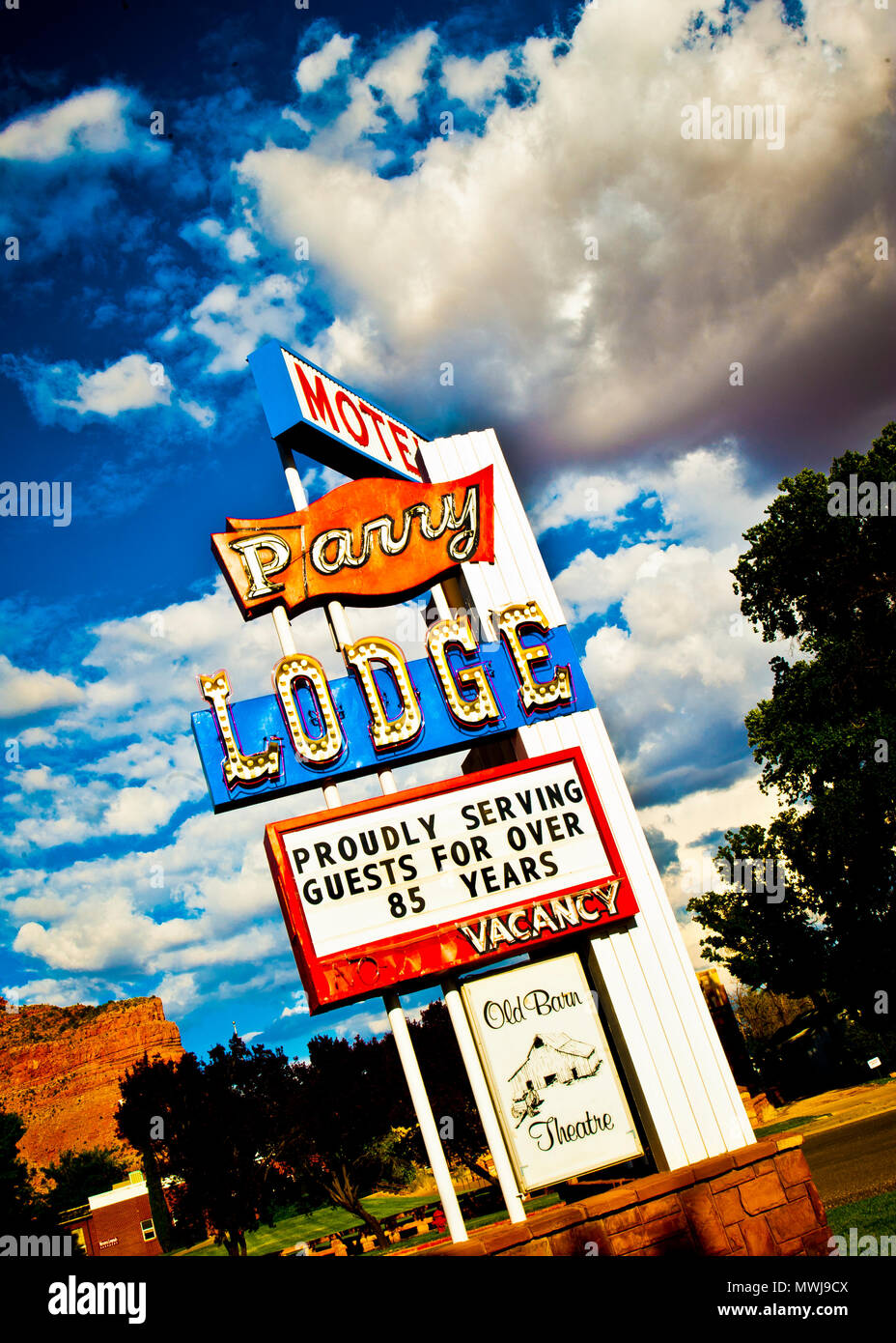 classic motel roadside neon sign with dramatic storm clouds overhead ...