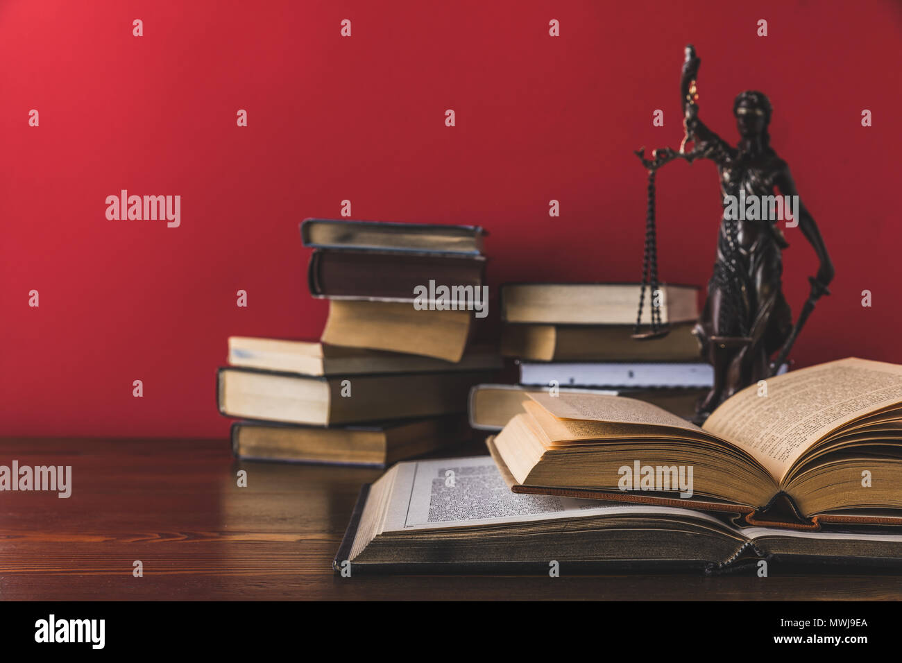 opened juridical books with lady justice statue on wooden table, law ...