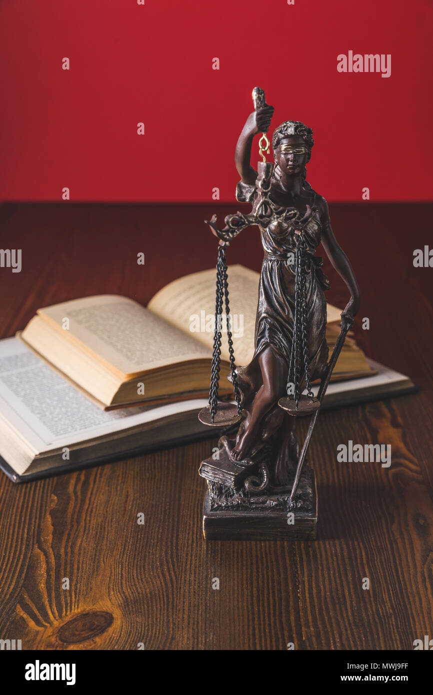 opened juridical books with lady justice statue on wooden table, law ...