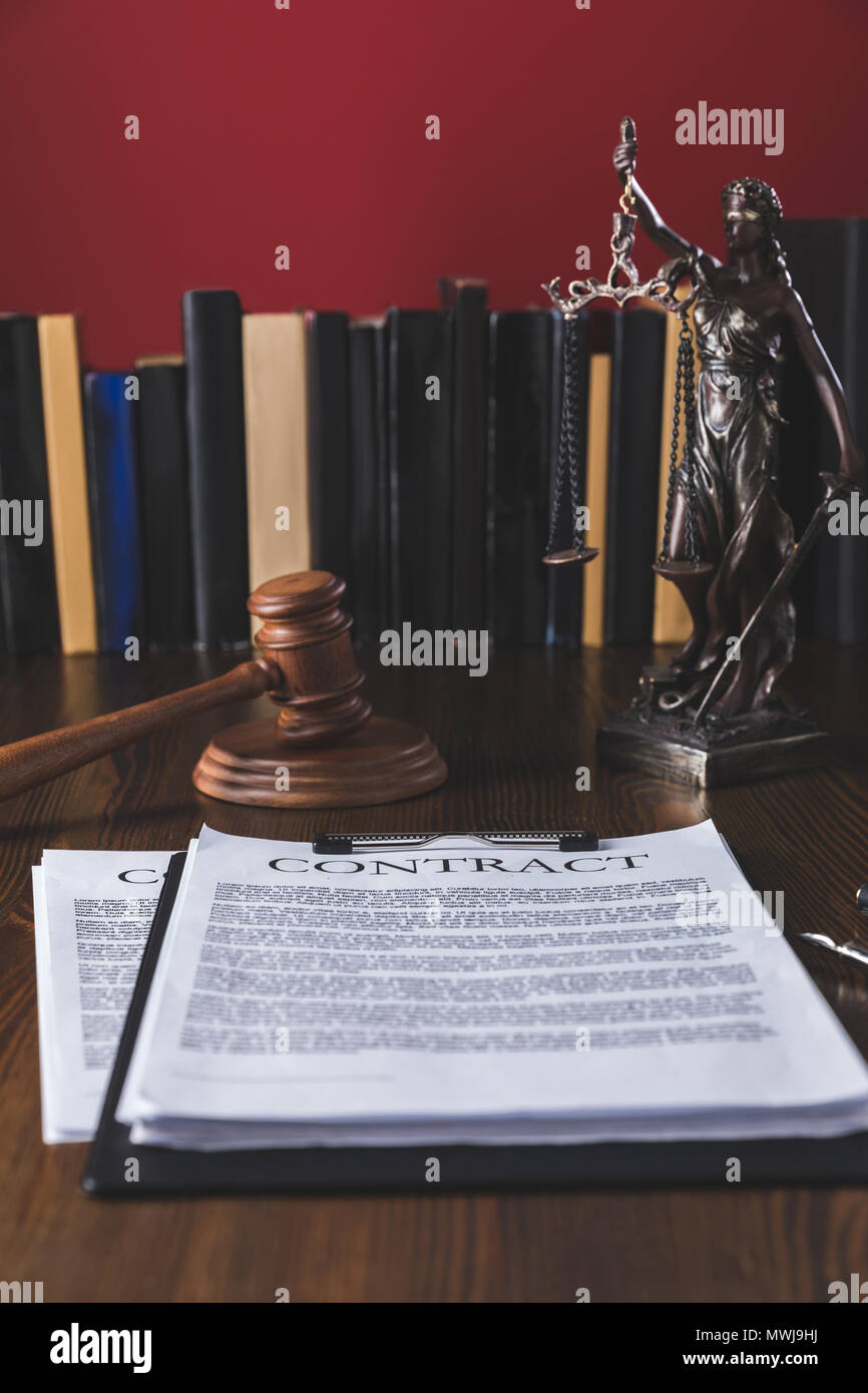 juridical contract on wooden table with hammer and lady justice, law ...